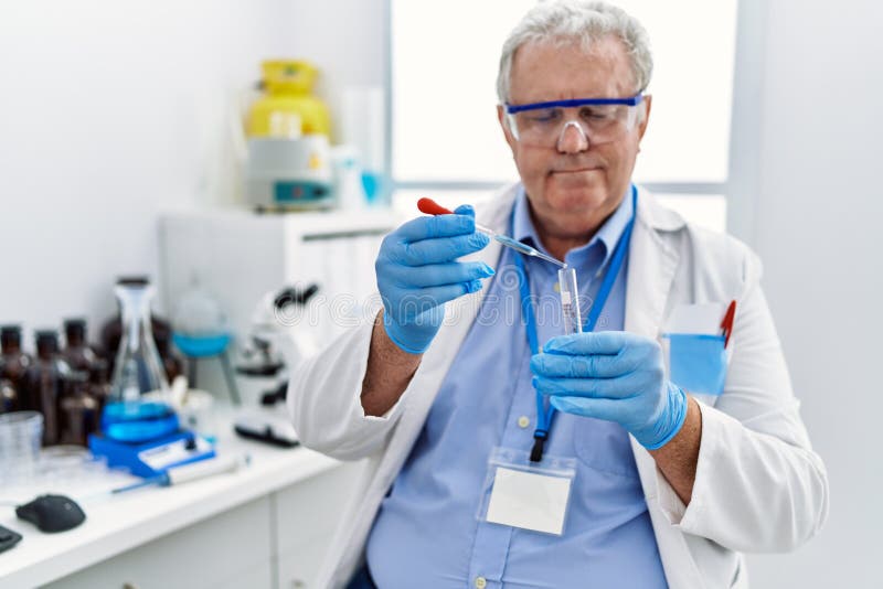 Middle Age Grey-haired Man Wearing Scientist Uniform Using Pipette at ...