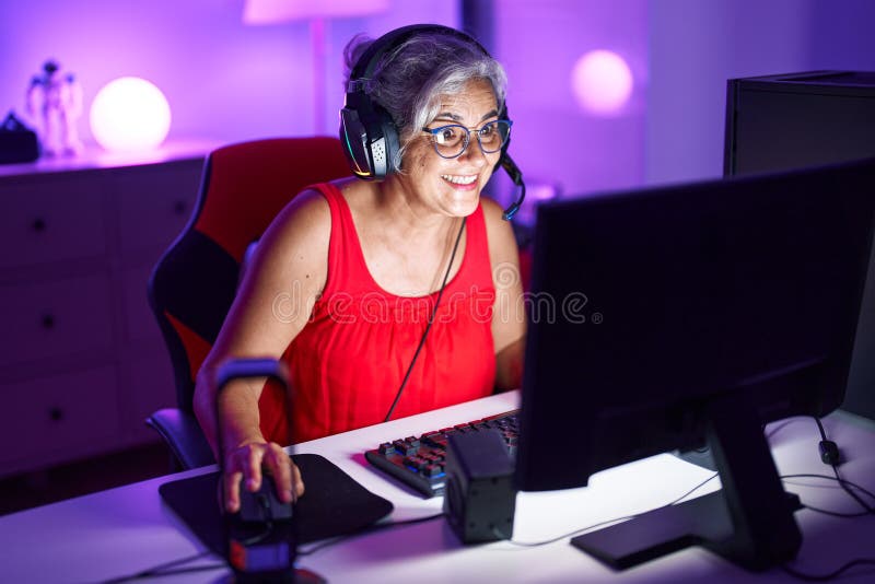 Middle Age Grey-haired Woman Streamer Playing Video Game Using Computer ...