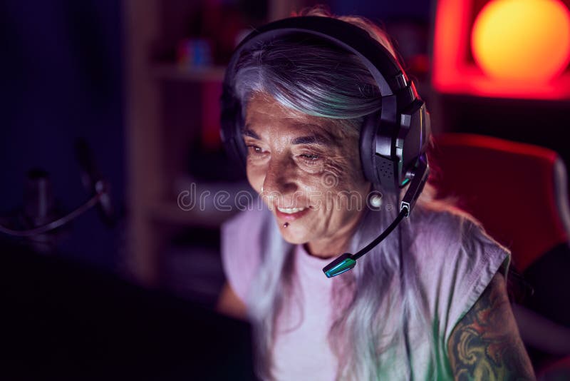Middle Age Grey-haired Woman Streamer Playing Video Game Using Computer ...