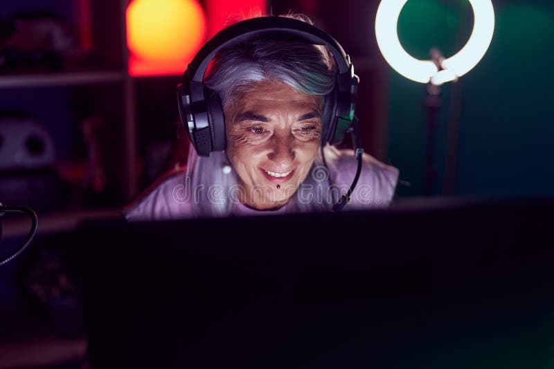 Middle Age Grey-haired Woman Streamer Playing Video Game Using Computer ...