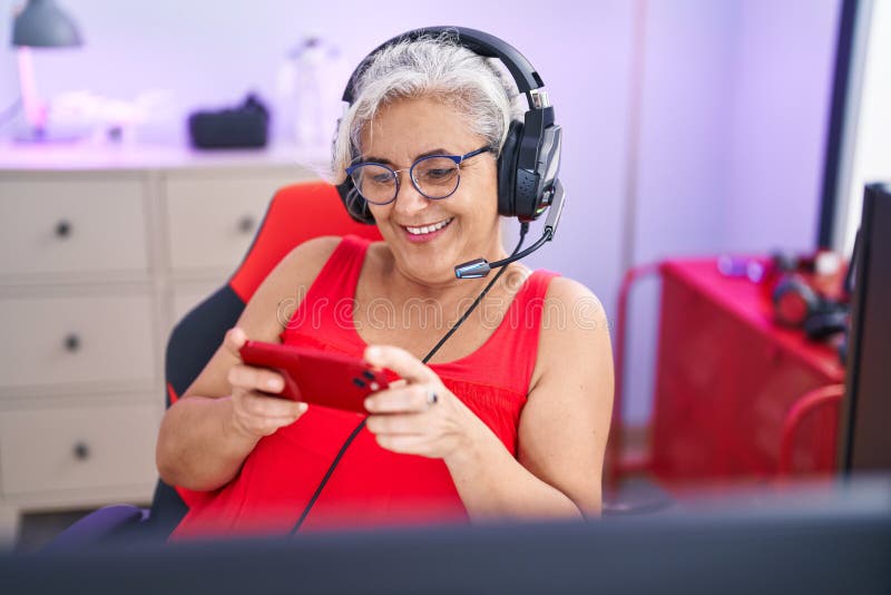 Middle Age Grey-haired Woman Streamer Using Computer and Smartphone at ...