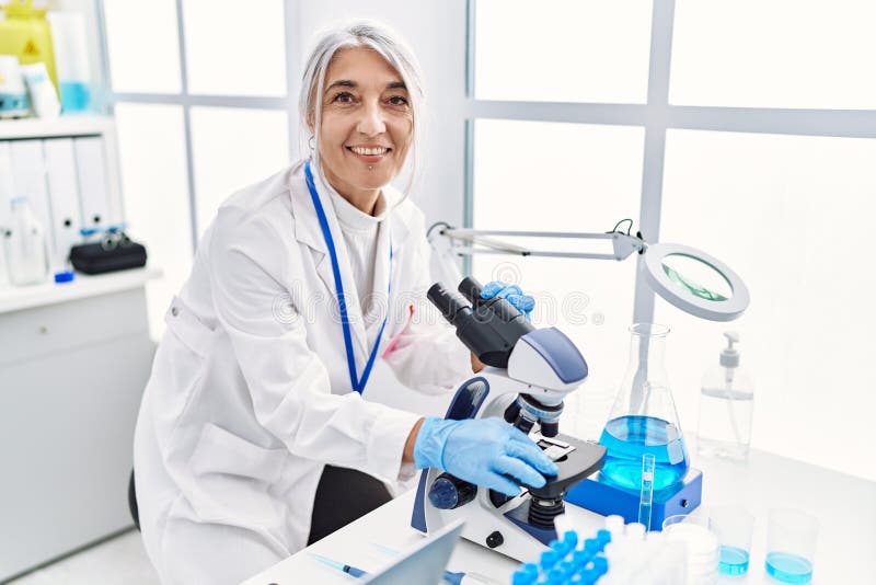 Middle Age Grey-haired Woman Wearing Scientist Uniform Using Microscope ...