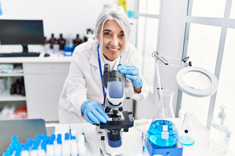 Middle Age Grey-haired Woman Wearing Scientist Uniform Using Microscope ...