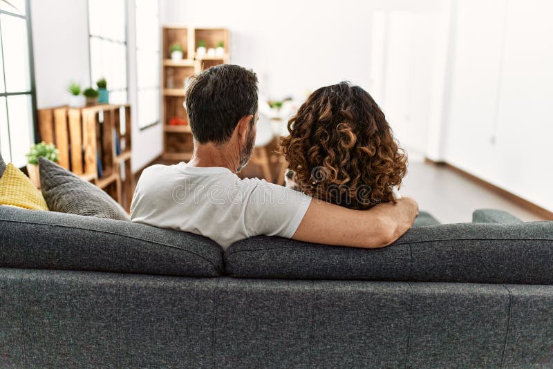 Middle Age Hispanic Couple on Back View Hugging and Sitting on the Sofa ...