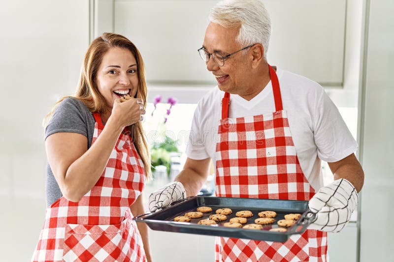 Middle Age Hispanic Couple Smiling Happy Baking Cookies at the Kitchen ...