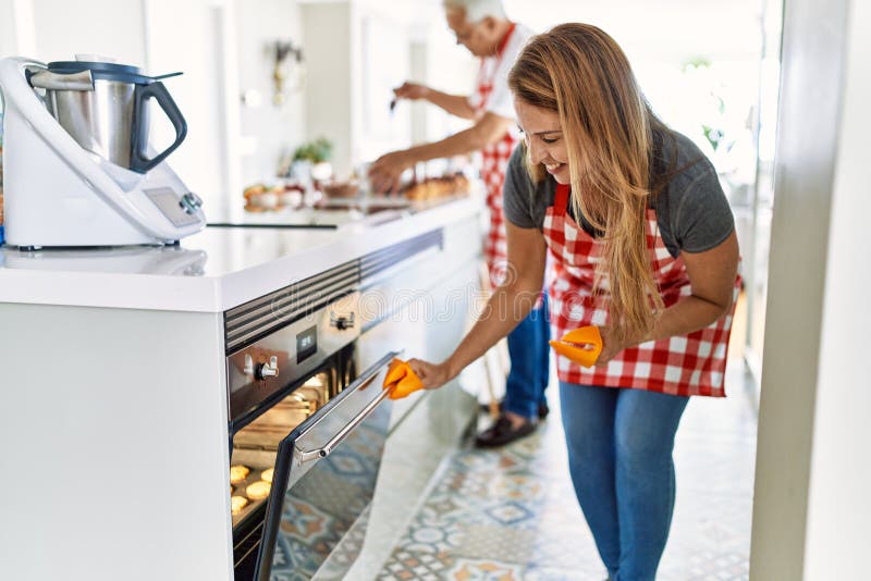 Middle Age Hispanic Couple Smiling Happy Baking Muffins at the Kitchen ...