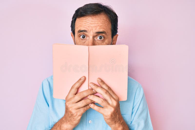 Middle Age Hispanic Man Reading Book Clueless and Confused Expression ...