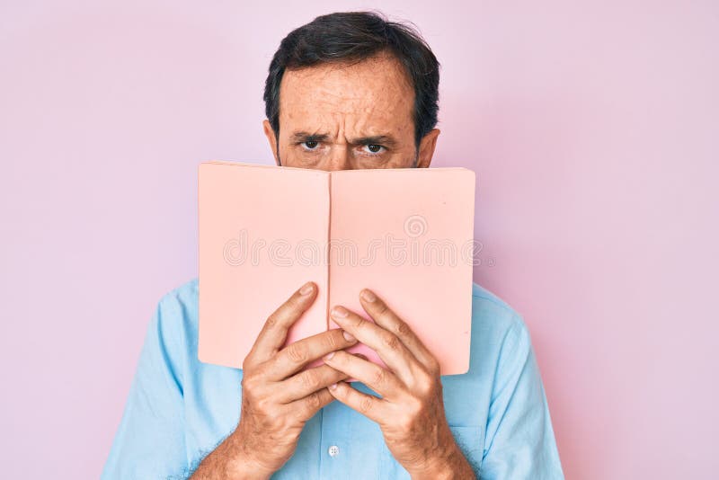 Middle Age Hispanic Man Reading Book Depressed and Worry for Distress ...