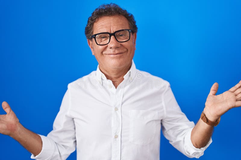 Middle Age Hispanic Man Standing Over Blue Background Clueless and ...