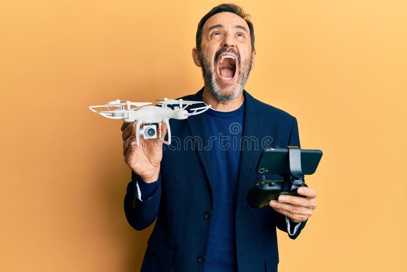 Middle Age Hispanic Man Using Drone Angry and Mad Screaming Frustrated ...