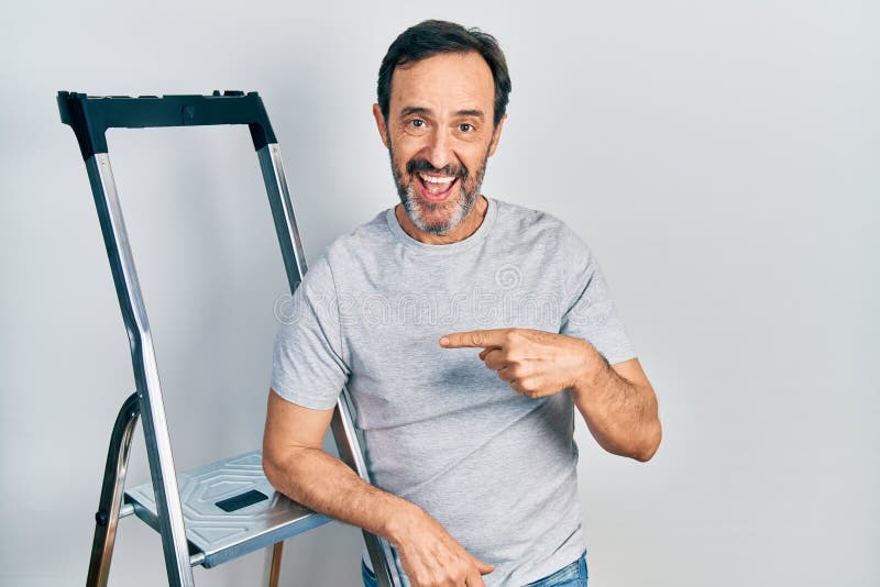 Middle Age Hispanic Man Using Ladder Smiling Happy Pointing with Hand ...