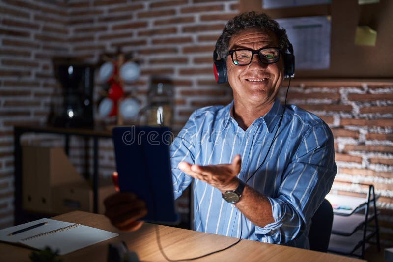 Middle Age Hispanic Man Using Touchpad Sitting on the Table at Night ...