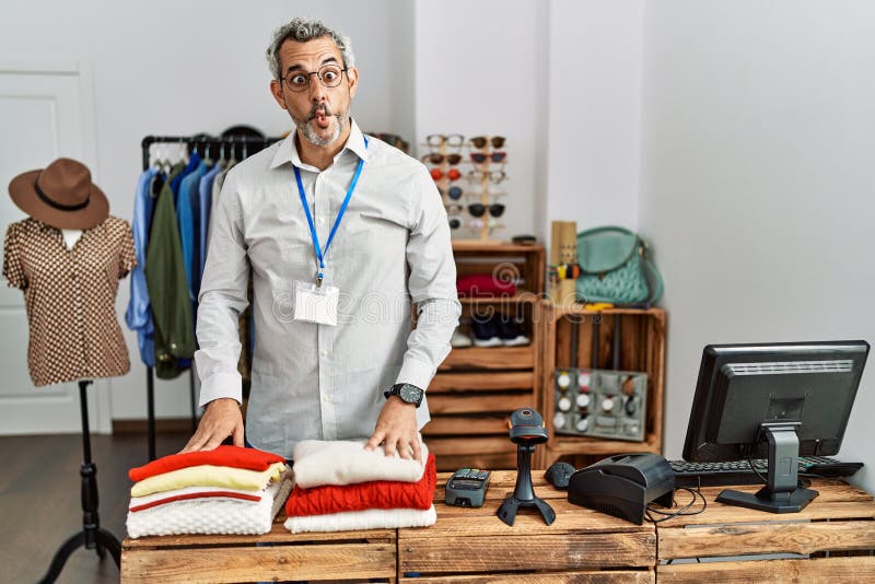 Middle Age Hispanic Man Working As Manager at Retail Boutique Making ...