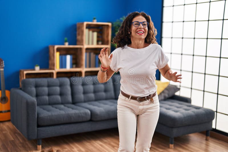 Middle Age Hispanic Woman Dancing at Home Stock Image - Image of home ...