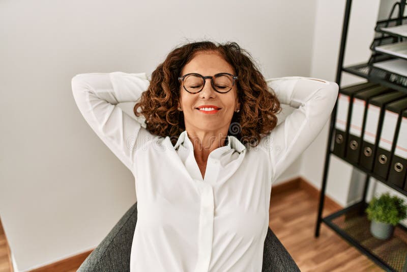 Middle Age Hispanic Woman Smiling Confident Relaxing at Office Stock ...