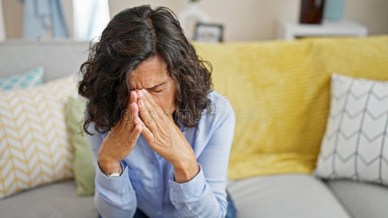 Middle Age Hispanic Woman Stressed Sitting on Sofa at Home Stock Photo ...