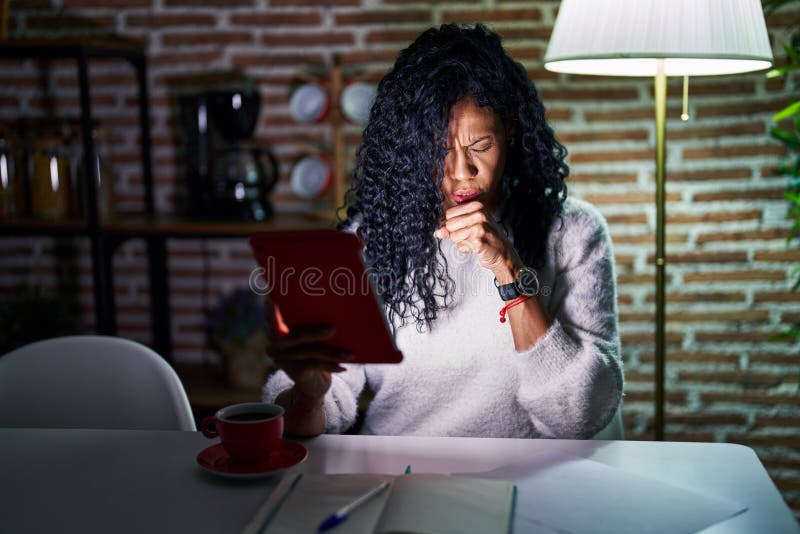 Middle Age Hispanic Woman Using Touchpad Sitting on the Table at Night ...