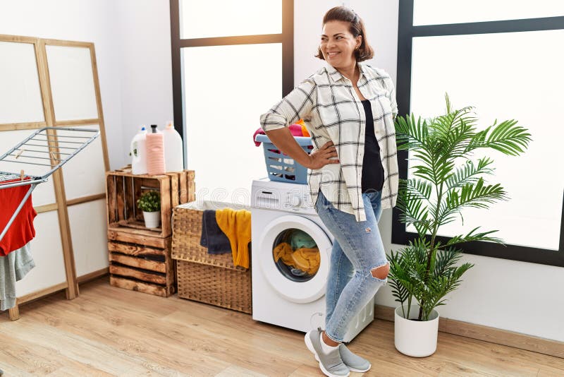 Middle Age Hispanic Woman Waiting for Washing Machine at Laundry Room ...