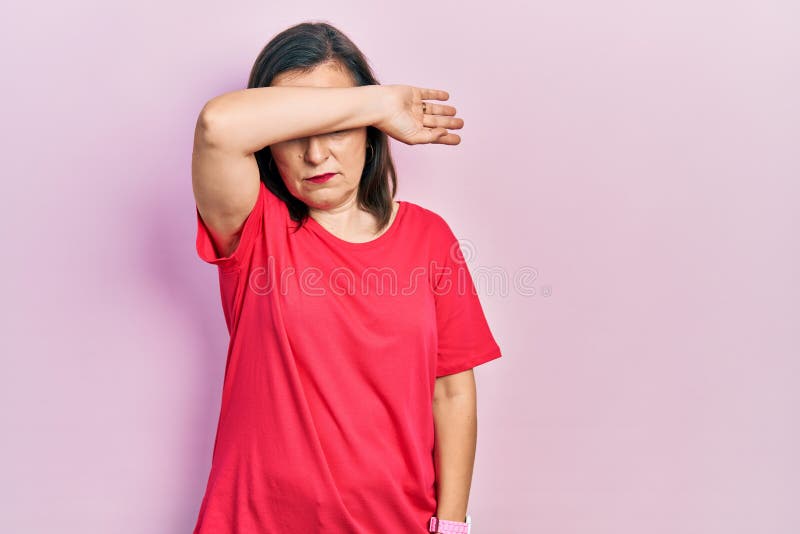 Middle Age Hispanic Woman Wearing Casual Clothes Covering Eyes With Arm