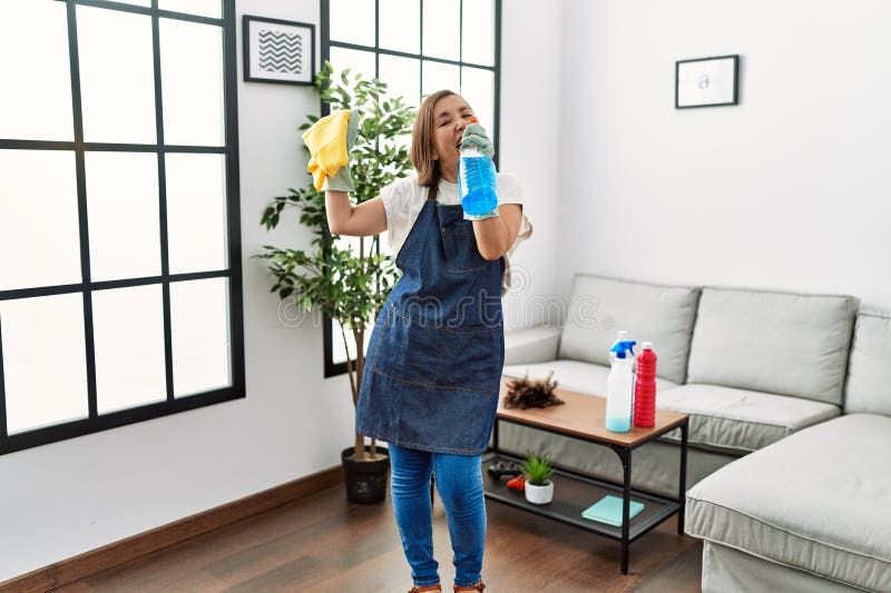 Middle Age Hispanic Woman Working As Housekeeper Dancing at Home Stock ...