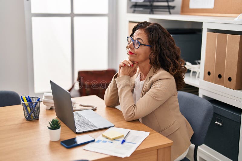 Middle Age Hispanic Woman Working with Laptop at the Office Stock Photo ...