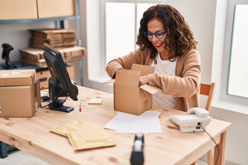 Middle Age Hispanic Woman Working Packing a Box at Ecommerce Stock ...