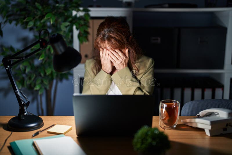 Middle Age Hispanic Woman Working Using Computer Laptop at Night with ...