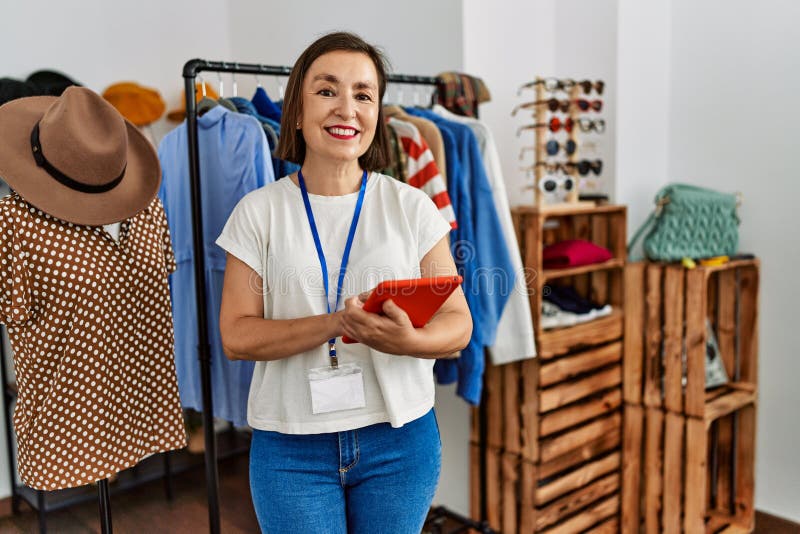 Middle Age Hispanic Woman Working Using Tablet Device at Retail Shop ...