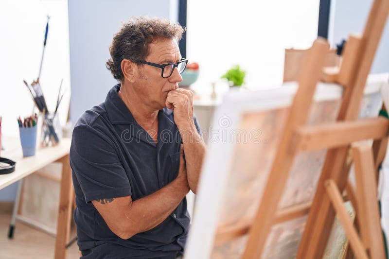 Middle Age Man Artist Looking Draw with Doubt Expression at Art Studio ...