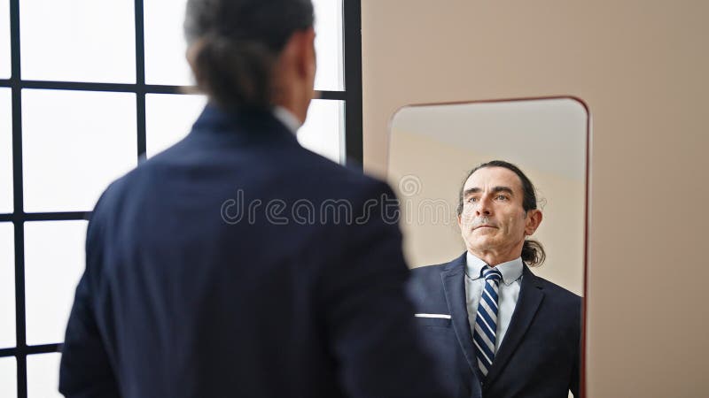 Middle Age Man Business Worker Looking on Mirror with Serious Face at ...