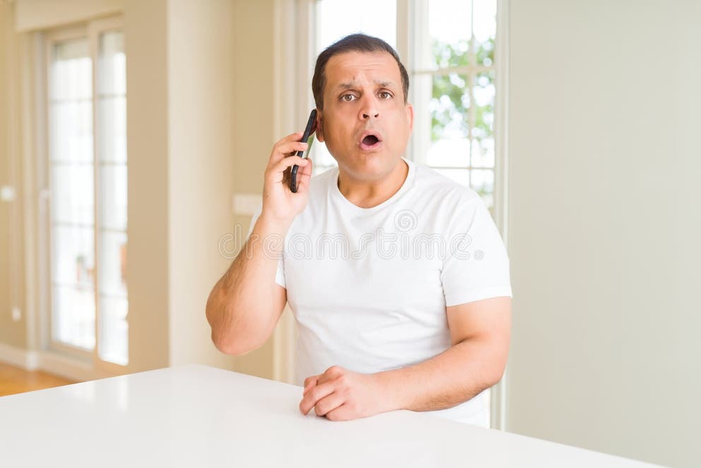 Middle Age Man Calling Using Smartphone Scared in Shock with a Surprise ...