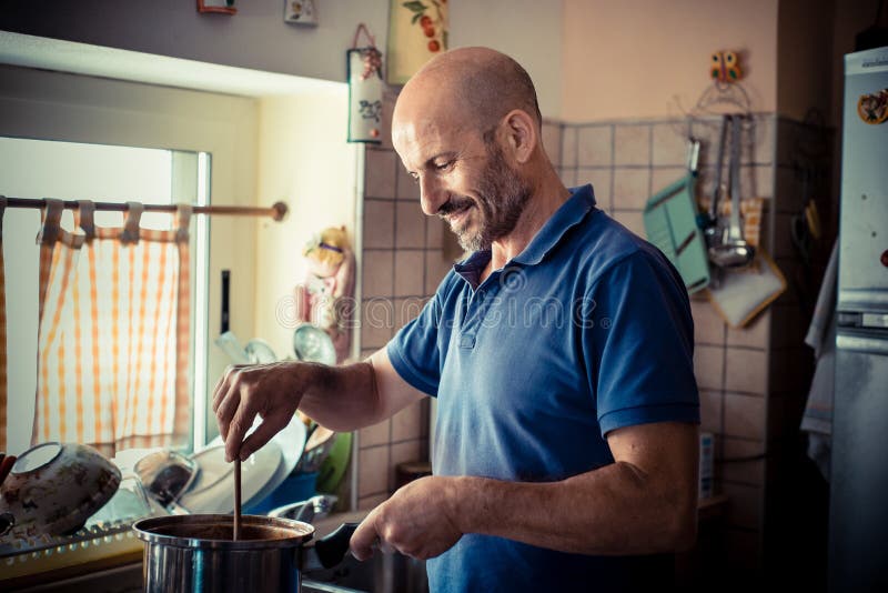 Middle age man cooking stock image. Image of casual, middle - 33317129