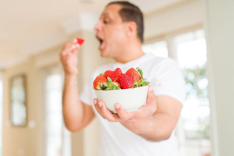 Middle Age Man Eating Strawberry at Home Stock Image - Image of bowl ...