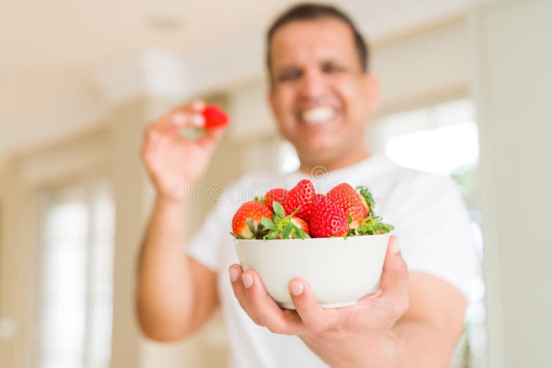 Middle Age Man Eating Strawberry at Home Stock Photo - Image of ...