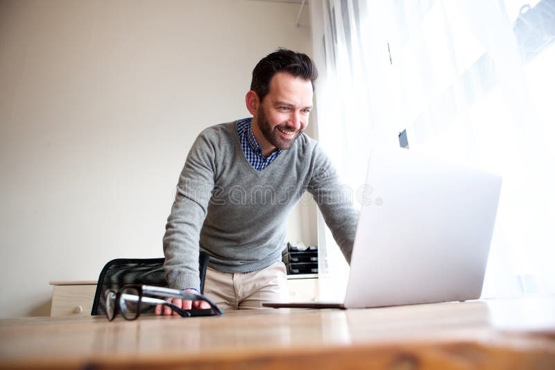 Man on Laptop Computer and Talking on Phone Stock Image - Image of ...