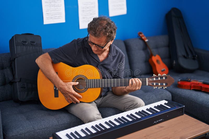 Middle Age Man Musician Playing Classical Guitar at Music Studio Stock ...
