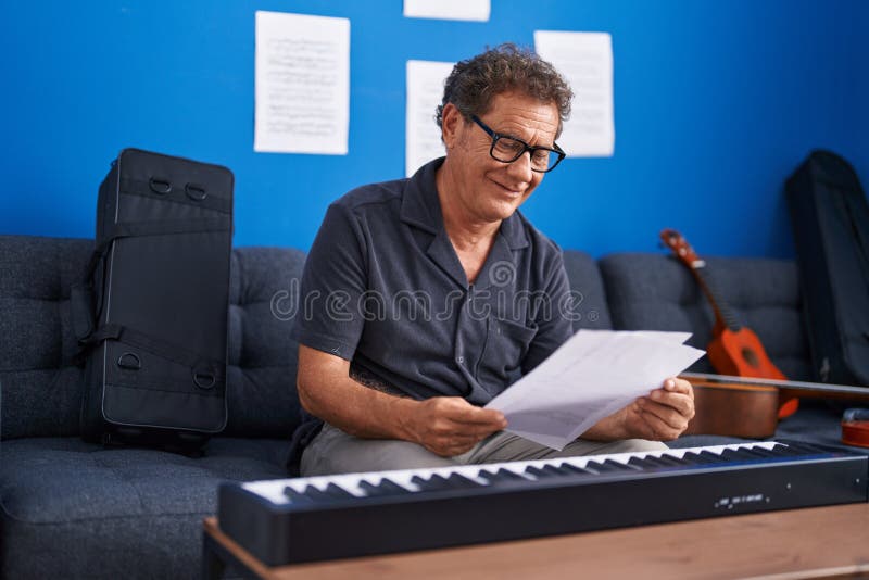 Middle Age Man Musician Smiling Confident Reading Music Sheet at Music ...