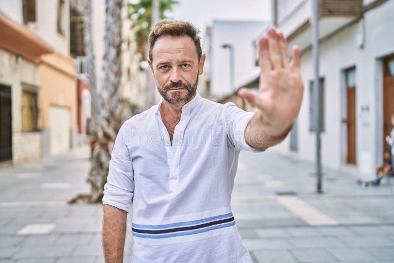 Middle Age Man Outdoor at the City Doing Stop Sing with Palm of the ...