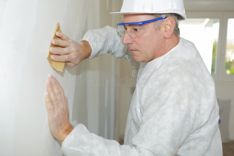 Middle-age Man Sand Papering Wall Stock Photo - Image of home, surface ...