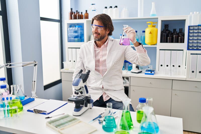 Middle Age Man Scientist Holding Test Tube at Laboratory Stock Photo ...
