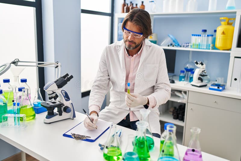 Middle Age Man Scientist Holding Test Tube Writing on Document at ...
