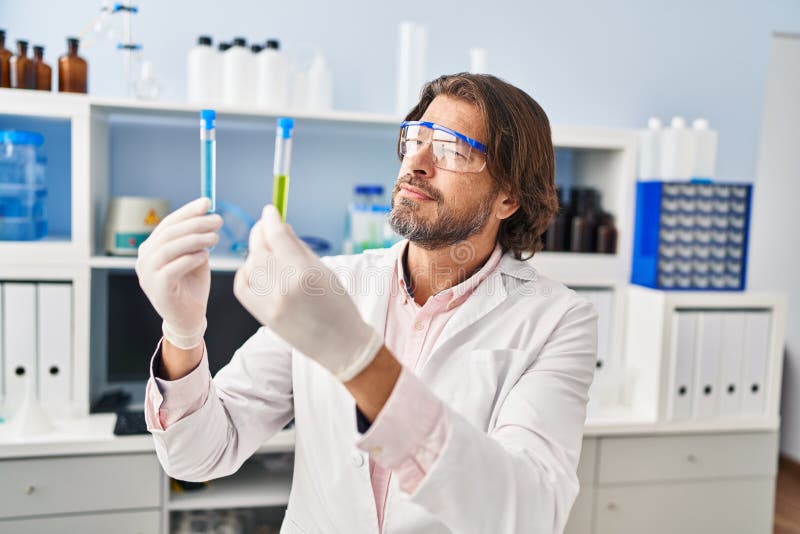 Middle Age Man Scientist Holding Test Tubes at Laboratory Stock Photo ...
