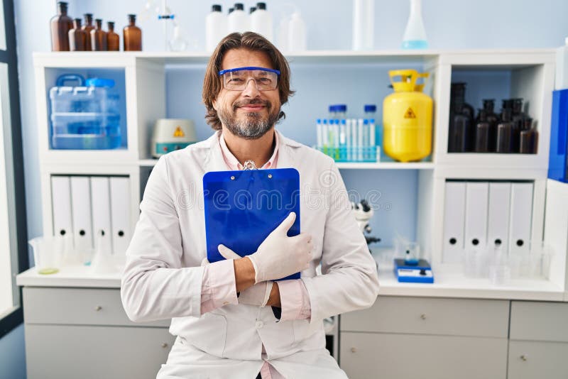 Middle Age Man Scientist Smiling Confident Holding Checklist at ...