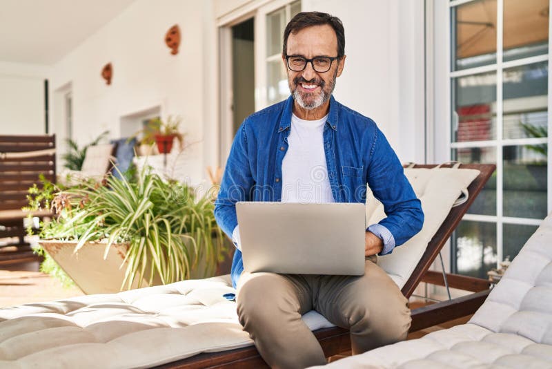Middle Age Man Smiling Confident Using Laptop at Terrace Home Stock ...