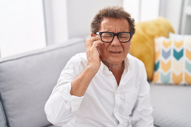 Middle Age Man Suffering for Ear Problem Sitting on Sofa at Home Stock ...