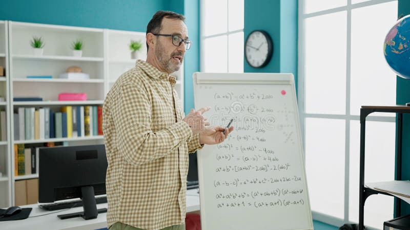 Middle Age Man Teacher Teaching Maths Lesson at Classroom Stock Image ...
