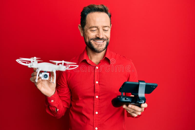 Middle Age Man Using Drone Smiling with a Happy and Cool Smile on Face ...