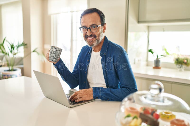 Middle Age Man Using Laptop Drinking Coffee at Home Stock Image - Image ...