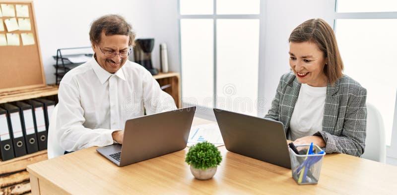 Middle Age Man and Woman Business Workers Using Laptop Working at ...