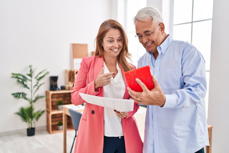 Middle Age Man and Woman Business Workers Using Touchpad Reading ...